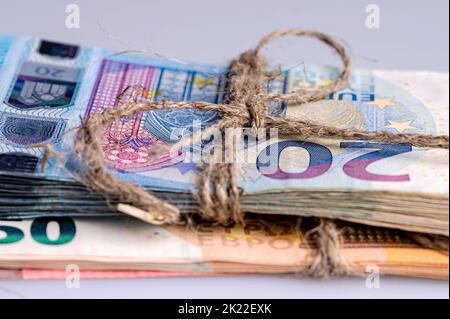 stack of euro banknotes tied with burlap string, closeup, wealth and ...