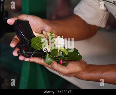 A priest blessing weapons belonging to TSR 2nd Battalion (Tripura State ...