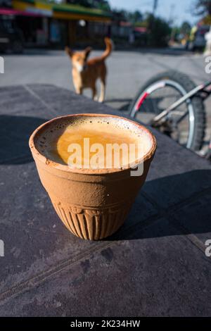 Hot Indian spiced tea served in a traditional clay pot glass called ...
