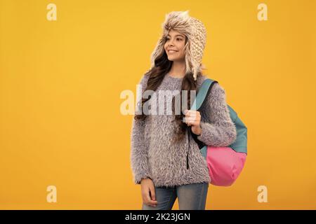happy teen girl in knitwear sweater and hat has long curly hair, kid ...