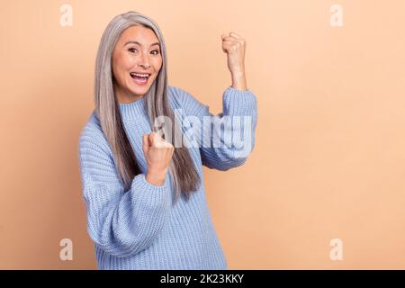 Photo of cheerful delighted girl raise fists triumph attainment toothy ...