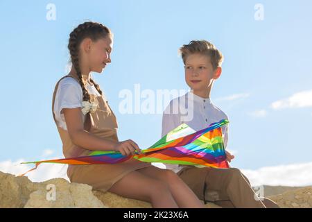Teenage friends met in nature, talking collecting a kite Stock Photo ...