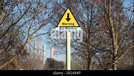 Warning gas pipeline sign and power station in the background Stock ...