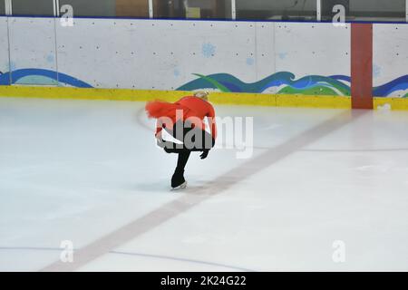 Girl figure skater rolls on a skating rink with artificial ice Stock ...
