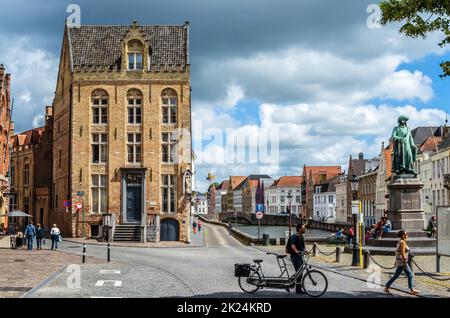 BRUGES, BELGIUM - AUGUST 18, 2013: Urban scene, old buildings along the ...