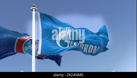 Basel, SWI, February 2022: The flag with the Gazprom logo fluttering in ...