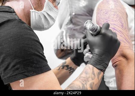 Tattoo artist making tattoo at the studio. High quality photography ...