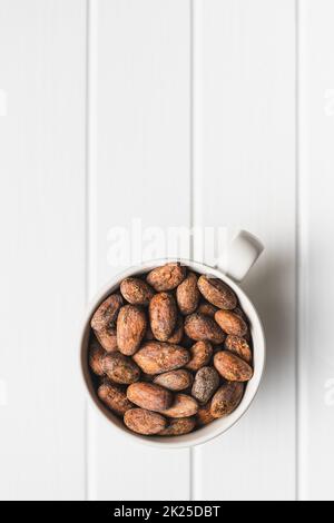 cacao beans and cacao powder in spoon Stock Photo - Alamy