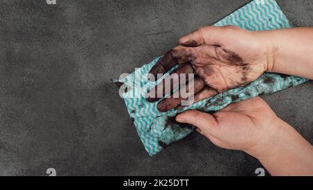 Cleaning dirty hands with a piece of clothes, fuel oil, mechanic worker ...