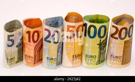 Rolls of multiple euro banknotes, euro bills stand side by side as one ...