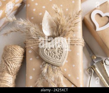 Valentines kraft paper wrapped present with vertical gift tag and ...
