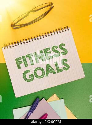 Text showing inspiration Fitness Goals. Word for Loose fat Build muscle ...