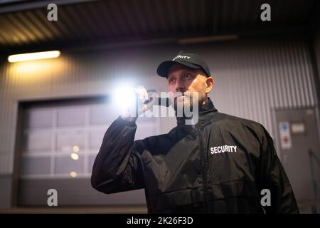 Security Guard Walking Building Perimeter With Flashlight At Night ...