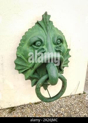 Bronze head fish sculpture isolated on a white wall. Bronze head fish ...