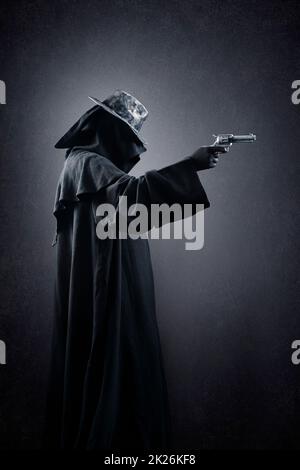 Creepy figure with old hat and gun in the dark Stock Photo - Alamy