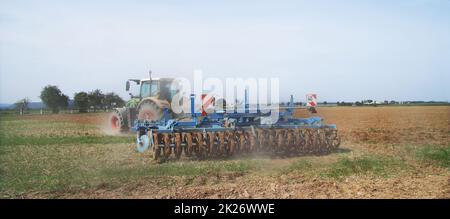Agricultural cultivating on farmland Stock Photo - Alamy