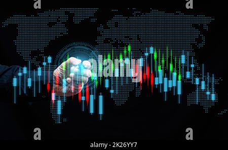 Businessman with blue shirt stands by high table and works with ...