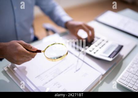 Auditor Using Magnifying Glass For Audit Stock Photo - Alamy