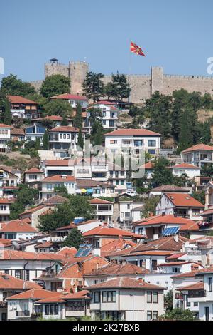 Many small houses on the coast of the Lake Ohrid with docks and moored ...