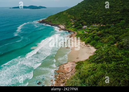 Coastline with beach, mountains and blue ocean with waves in Brazil ...