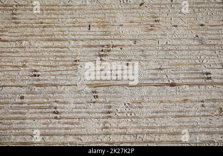 Wooden boards, wooden planks corrugated and covered with sand as a ...