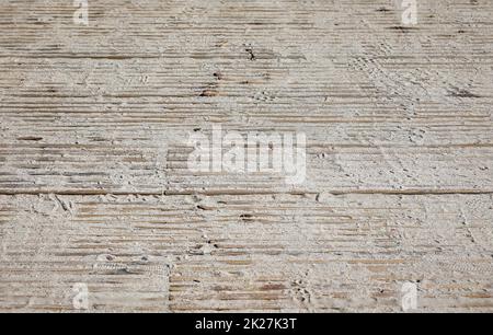 Wooden boards, wooden planks corrugated and covered with sand as a ...
