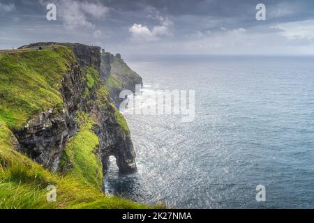 Natural rock arch, part of iconic Cliffs of Moher, popular tourist ...