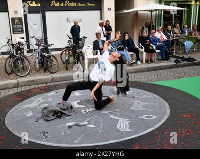 Avant-garde fashion parade show outside cafe restaurant in Tours ...