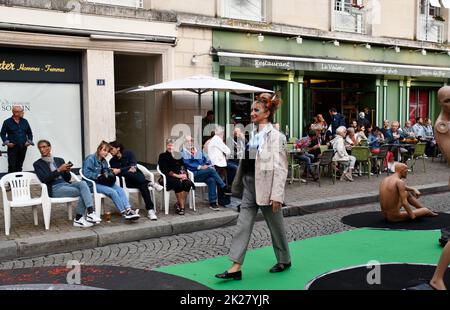 Avant-garde fashion parade show outside cafe restaurant in Tours ...