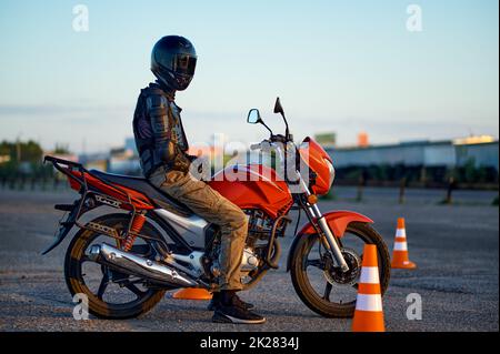 Male student poses on motorbike, motorcycle school Stock Photo - Alamy