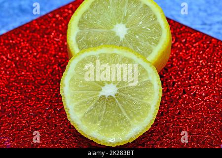 lemon slice on a red shiny enamelled plate Stock Photo - Alamy