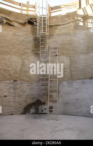 Ladder leading up from a pit Stock Photo - Alamy