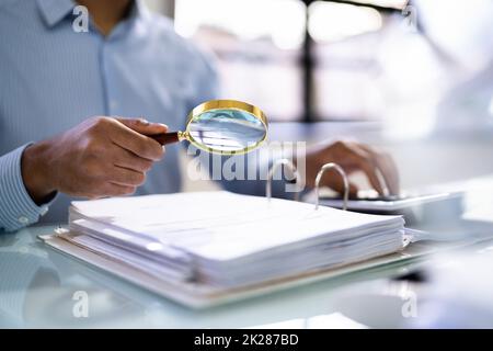 Auditor Using Magnifying Glass For Audit Stock Photo - Alamy