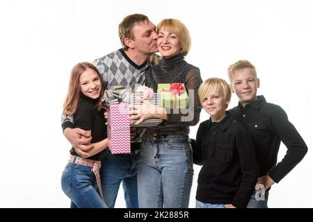 family portrait. mom hugs and kisses her little daughter against the ...