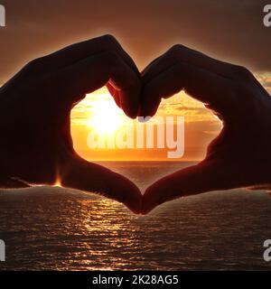 Hand shaped heart against sunset. Valentines day concept Stock Photo ...