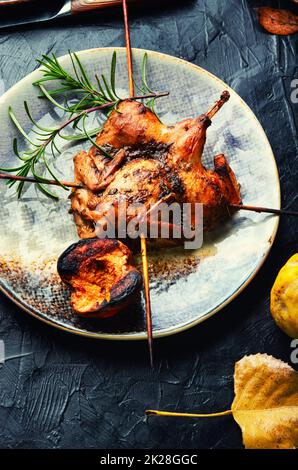 Quail barbecue with quince Stock Photo - Alamy