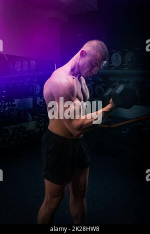 Back of bodybuilder lifting heavy weight. Strong bodybuilder building ...