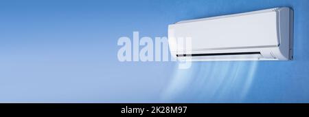 Air conditioning inside the living room. White fluffy cat Kurilian ...