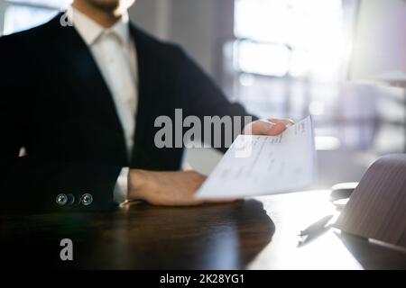 Hand Giving Payroll Cheque. Paycheck In Hand Stock Photo - Alamy