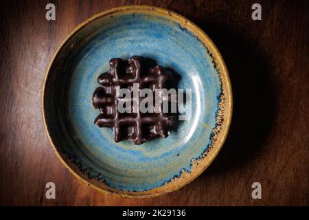 Chocolate waffle in handmade clay plate Stock Photo - Alamy
