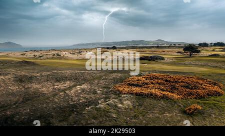 Irish coastline dunes with a moody sky over the beach. Portmarnock ...