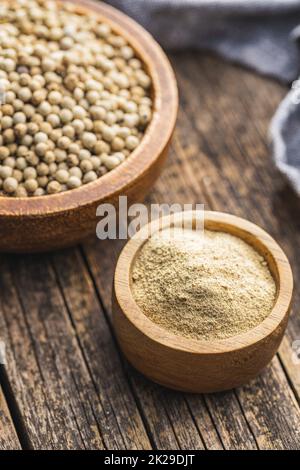 White ground pepper and whole peppercorn spice isolated on white ...
