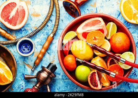 Smoking shisha with citrus fruits Stock Photo - Alamy
