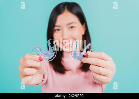 woman smiling hold silicone orthodontic retainers for teeth Stock Photo ...
