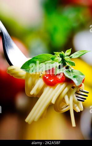 Spaghetti fork on dark black background / Traditional delicious food ...