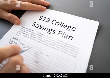 529 College Savings Plan Form With Small Graduation Hat, Spectacles And Pen Over White ...