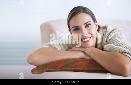 Making the most of her time off. an attractive young woman relaxing on ...