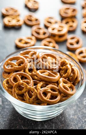 Mini pretzels. Crusty salted snack on wooden table Stock Photo - Alamy