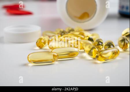 Gold fish oil isolated on white background Stock Photo - Alamy