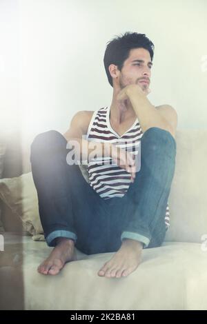 Man lounging on sofa Stock Photo - Alamy